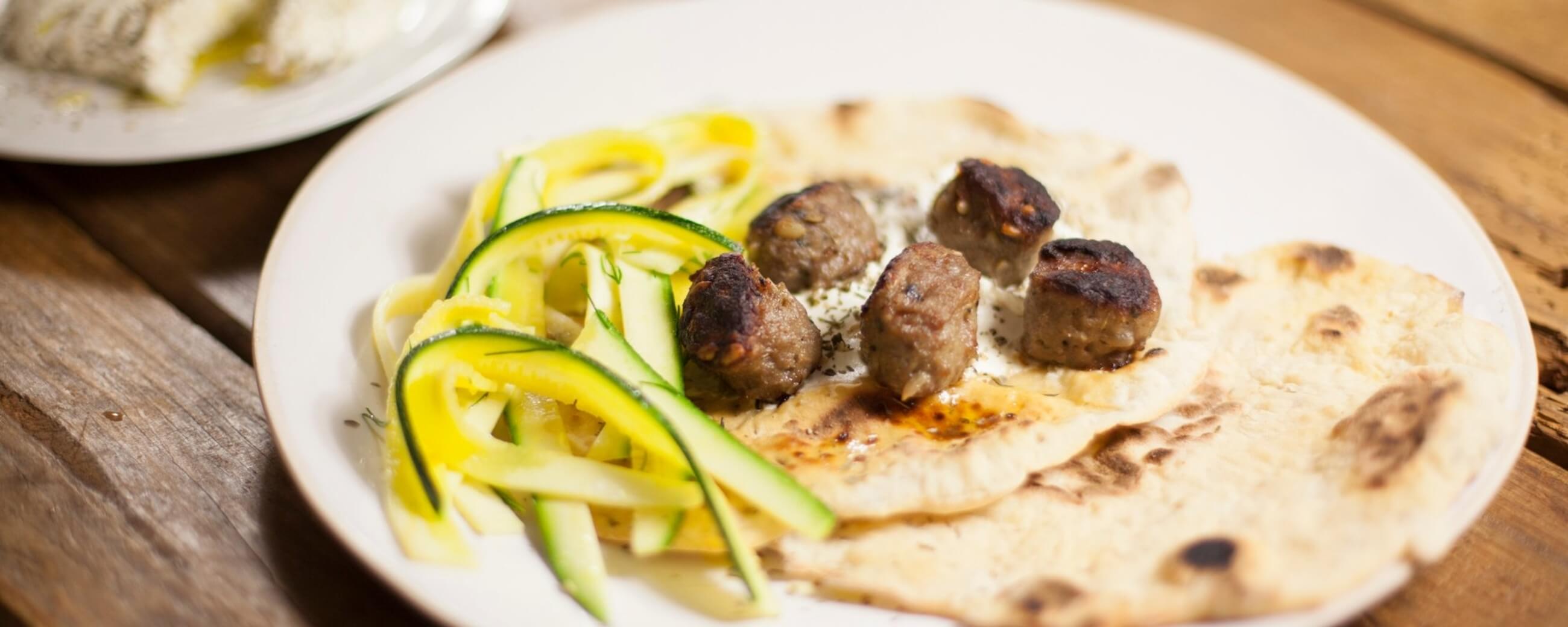 Courgette ribbon salad with kofta, yoghurt and cumin flatb... / Riverford