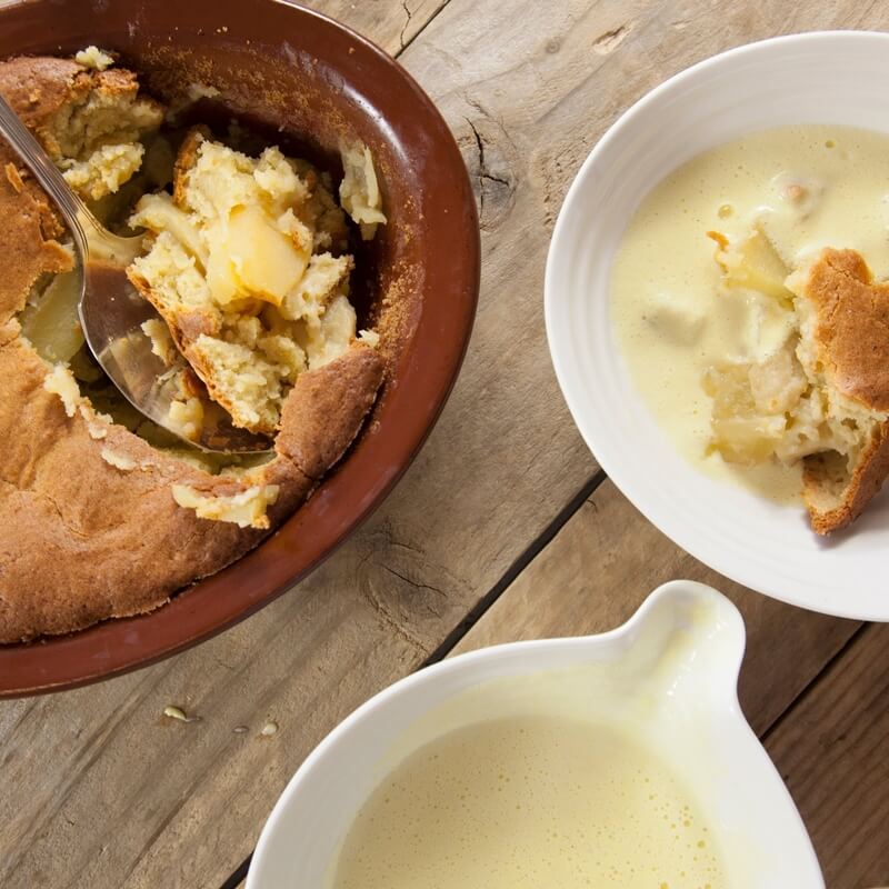 Baked Eve's pudding with homemade custard recipe / Riverford