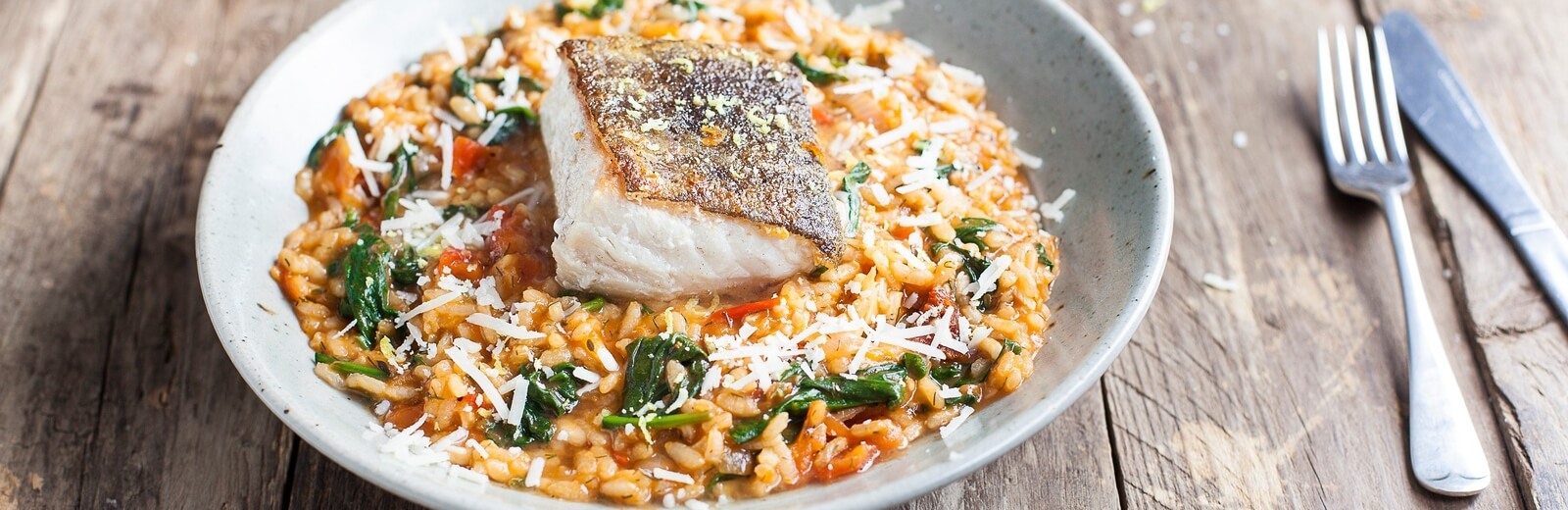 Spinach and tomato risotto with crispy pan-fried fish / Riverford