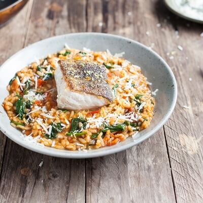 Spinach and tomato risotto with crispy pan-fried fish / Riverford