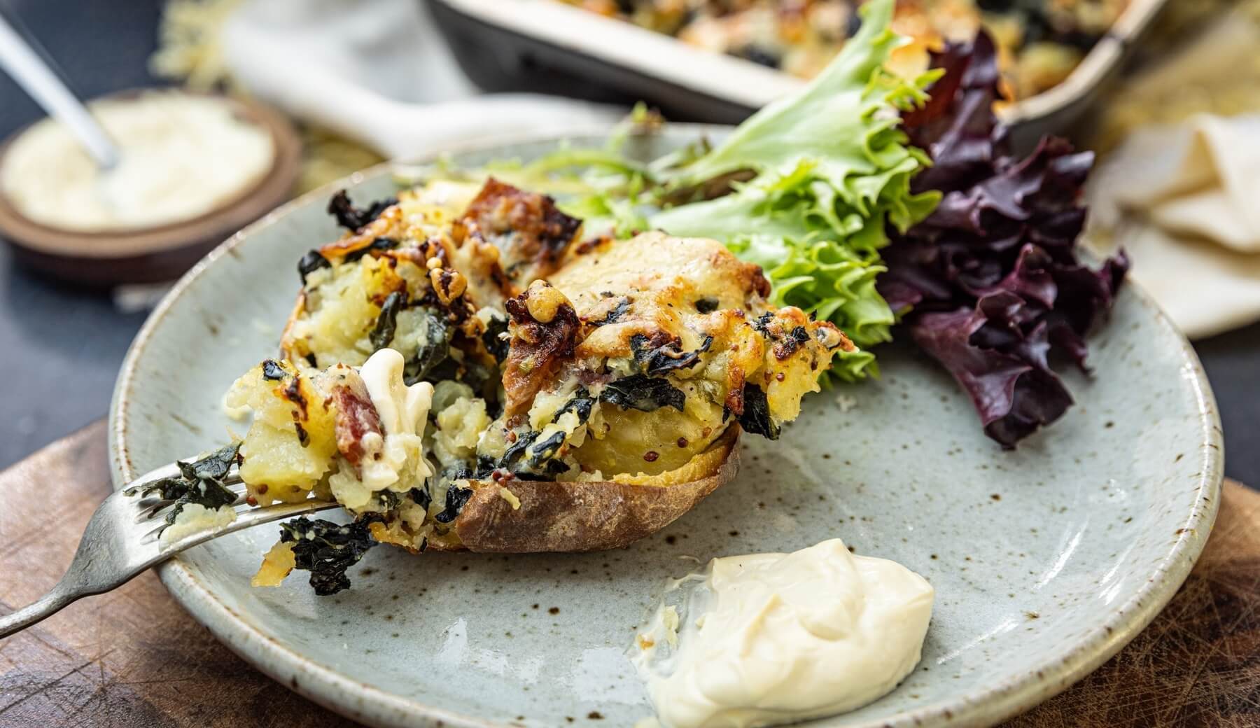 Loaded jackets with black kale, cheddar & bacon recipe / Riverford