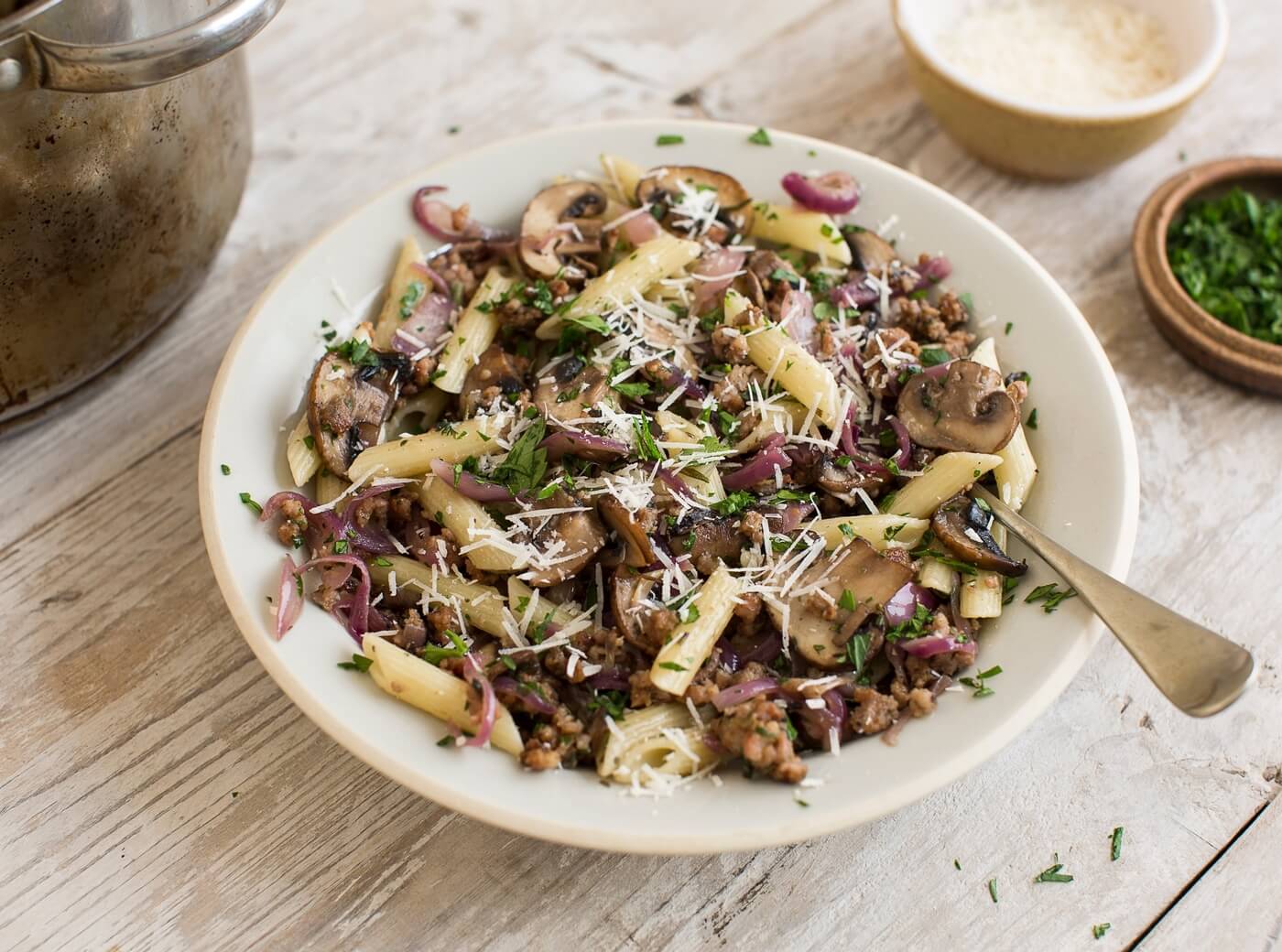 Sausage & caramelised red onion pasta with mushrooms & ros... / Riverford